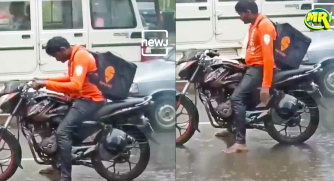 Swiggy Delivery Boy Waits in Rain at Traffic Lights